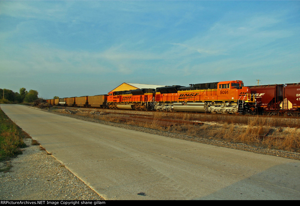 BNSF 9091 rocks a coal load Sb and shining on.